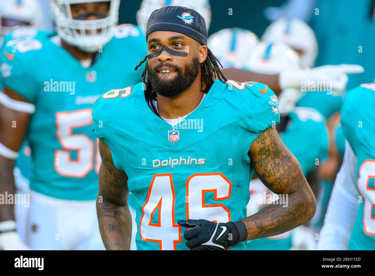 Miami Dolphins cornerback Mark Gilbert (46) runs onto the field with ...