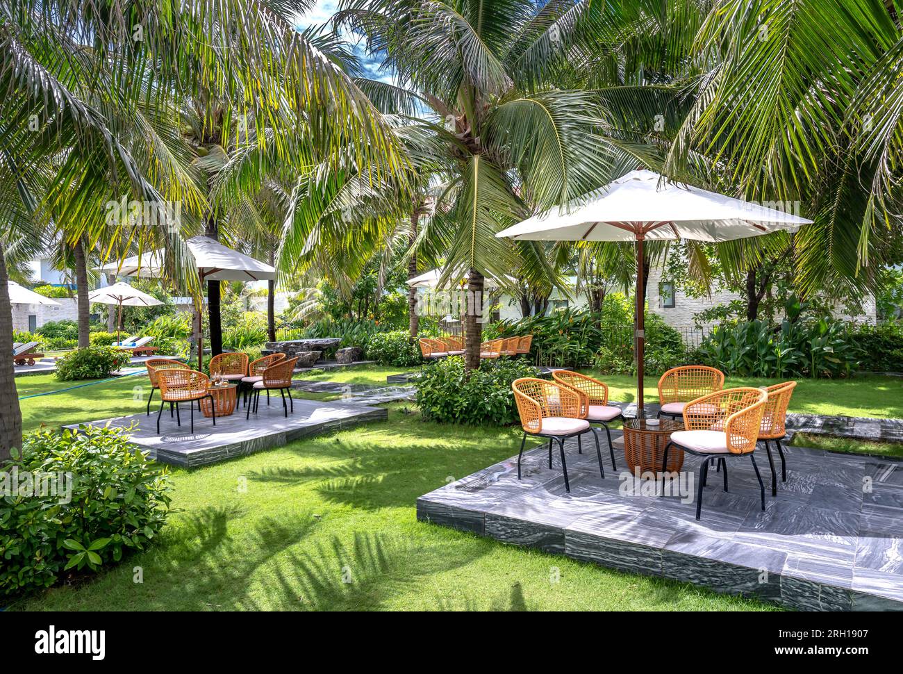 bamboo and rattan tables and chairs in a quiet and green tropical ...
