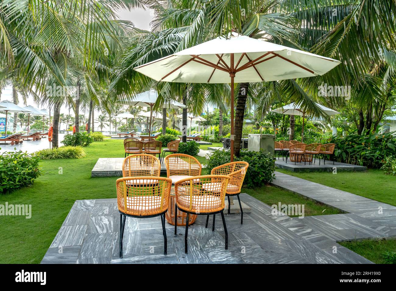bamboo and rattan tables and chairs in a quiet and green tropical ...