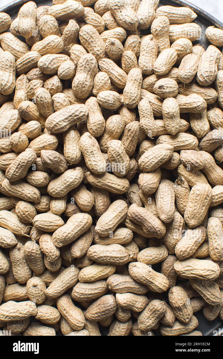 Top view of groundnuts in the shell, flatlay of shelled and unshelled ...