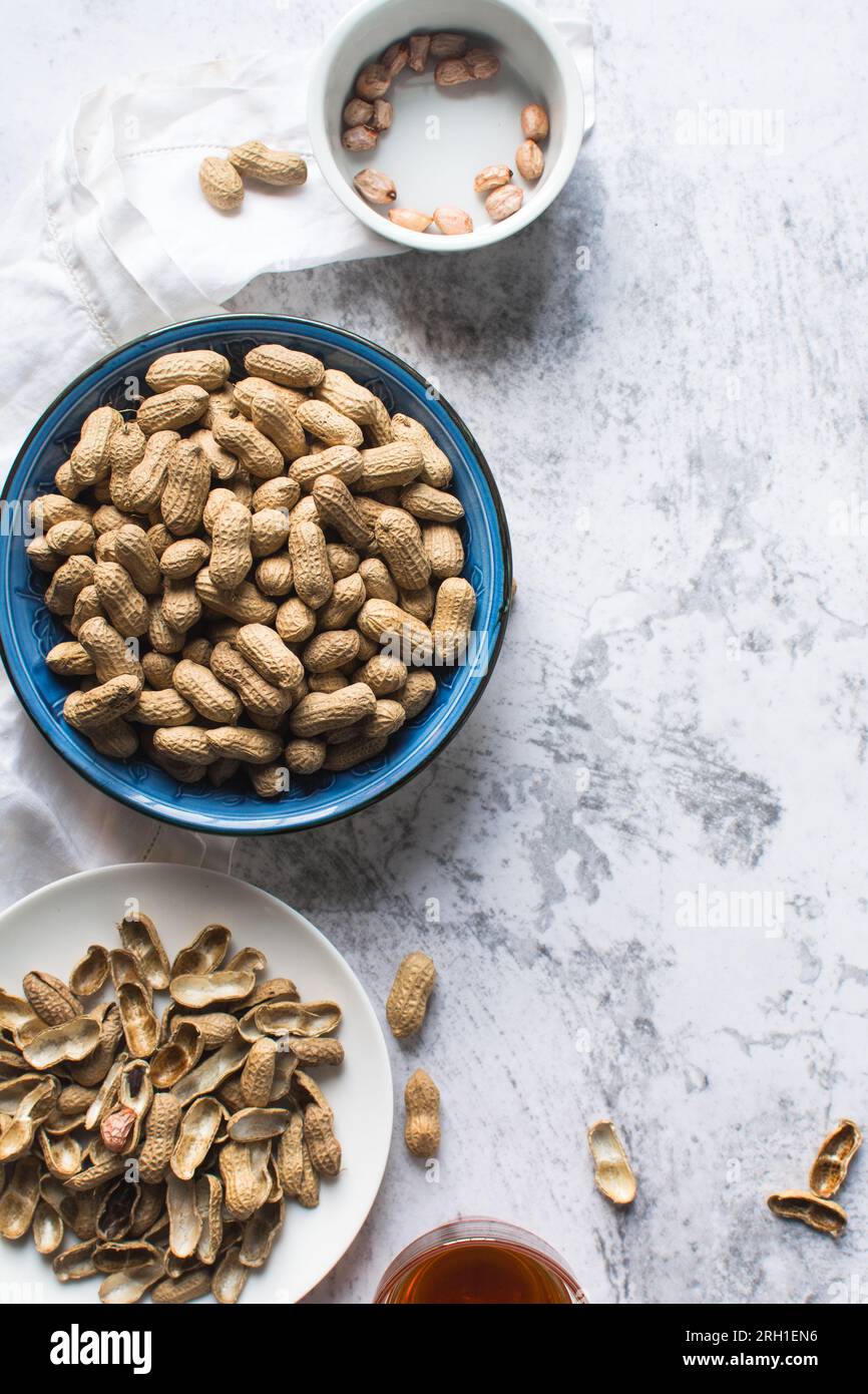 Top view of shelled groundnut in a blue plate, flatlay of shelled ...