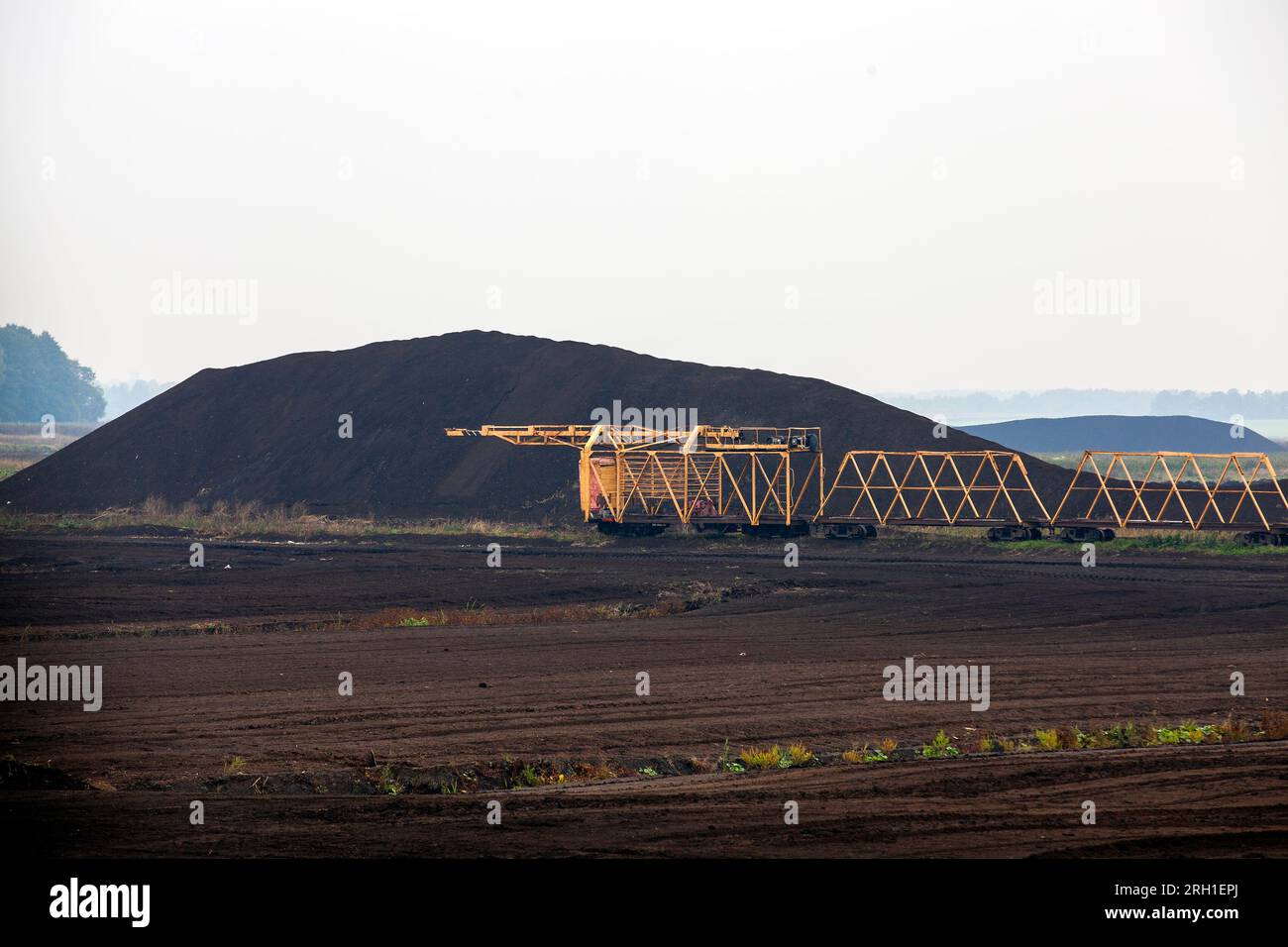 industrial area where black peat is mined, landscape in nature on the ...