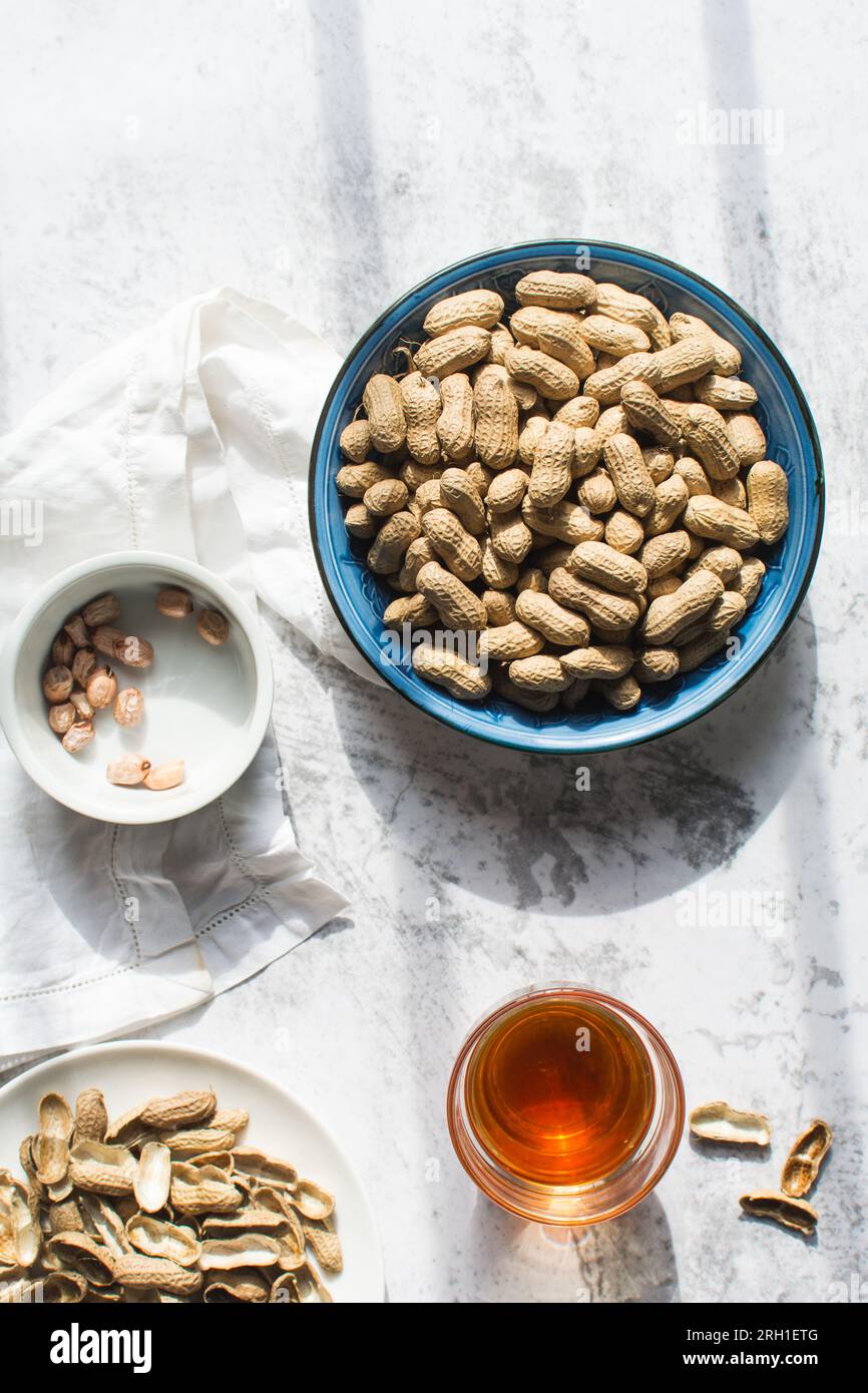 Top view of shelled groundnut in a blue plate, flatlay of shelled ...