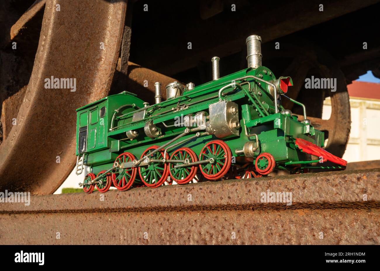 Green steam locomotive with red wheels on a railway track Stock Photo ...