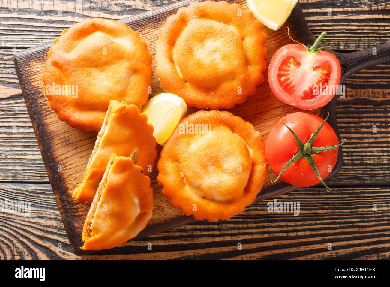 Octopus pie for Sete Tielle Setoise closeup on a wooden board on the ...