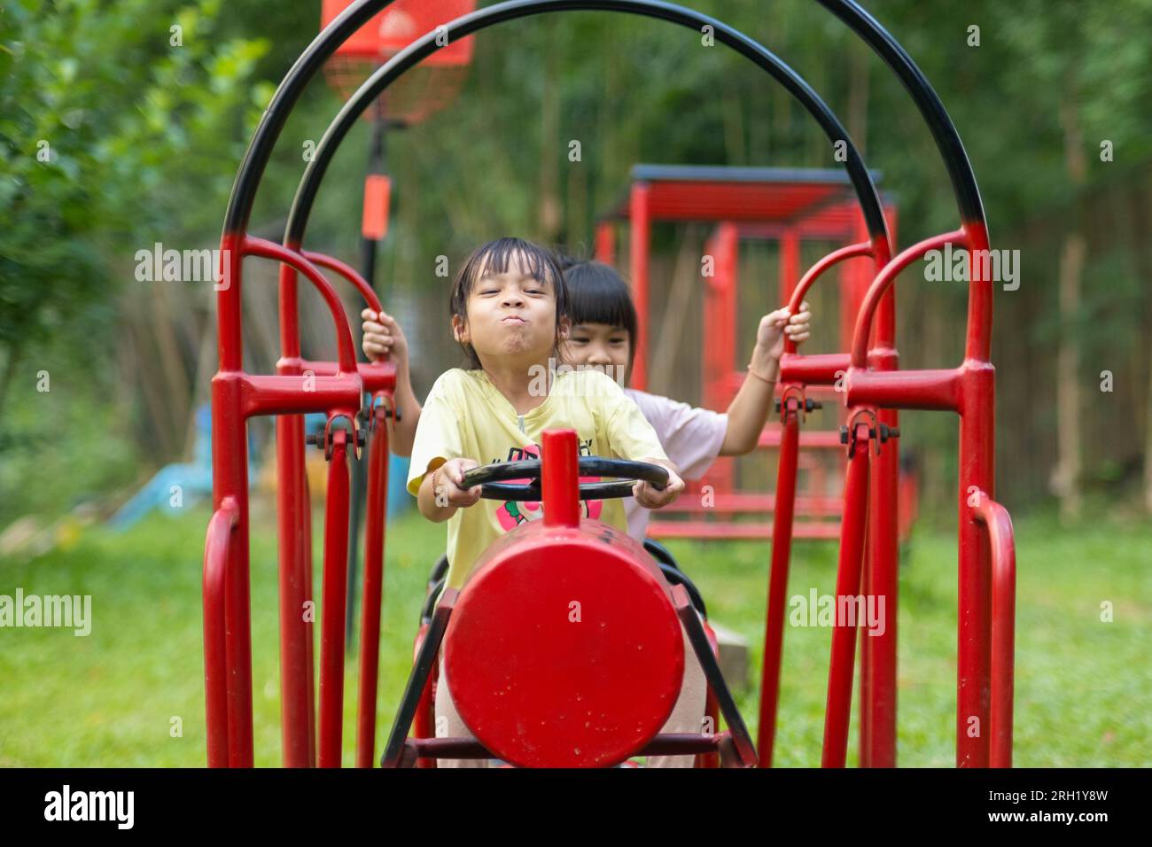 Two little girl playing at outdoor playground. Active children play on ...