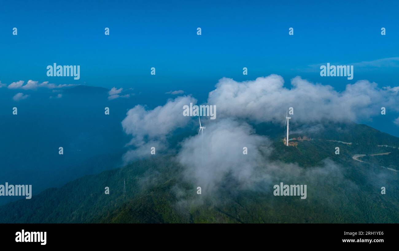 YICHUN, CHINA - AUGUST 12, 2023 - A wind power facility rotates under a ...