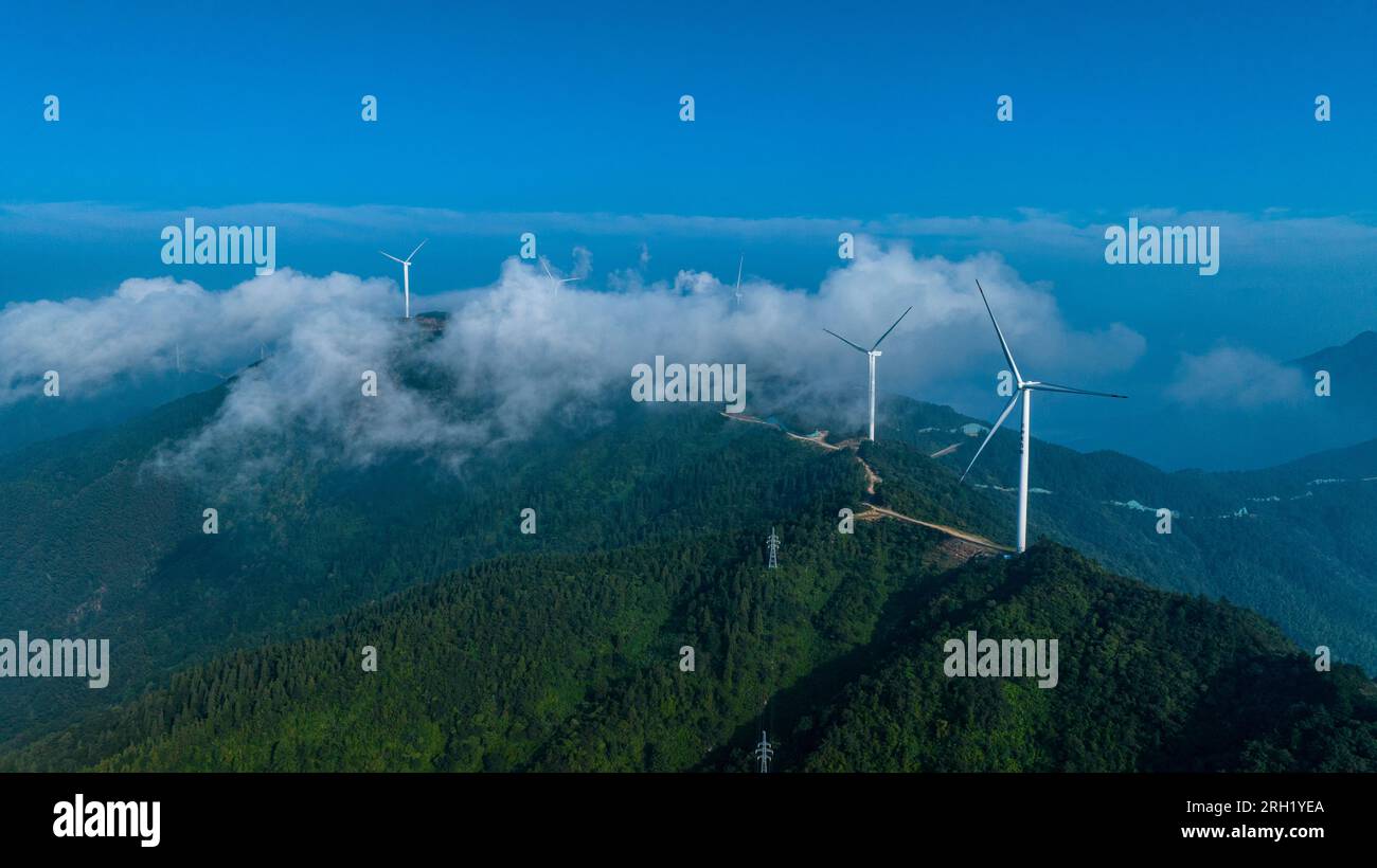 YICHUN, CHINA - AUGUST 12, 2023 - A wind power facility rotates under a ...