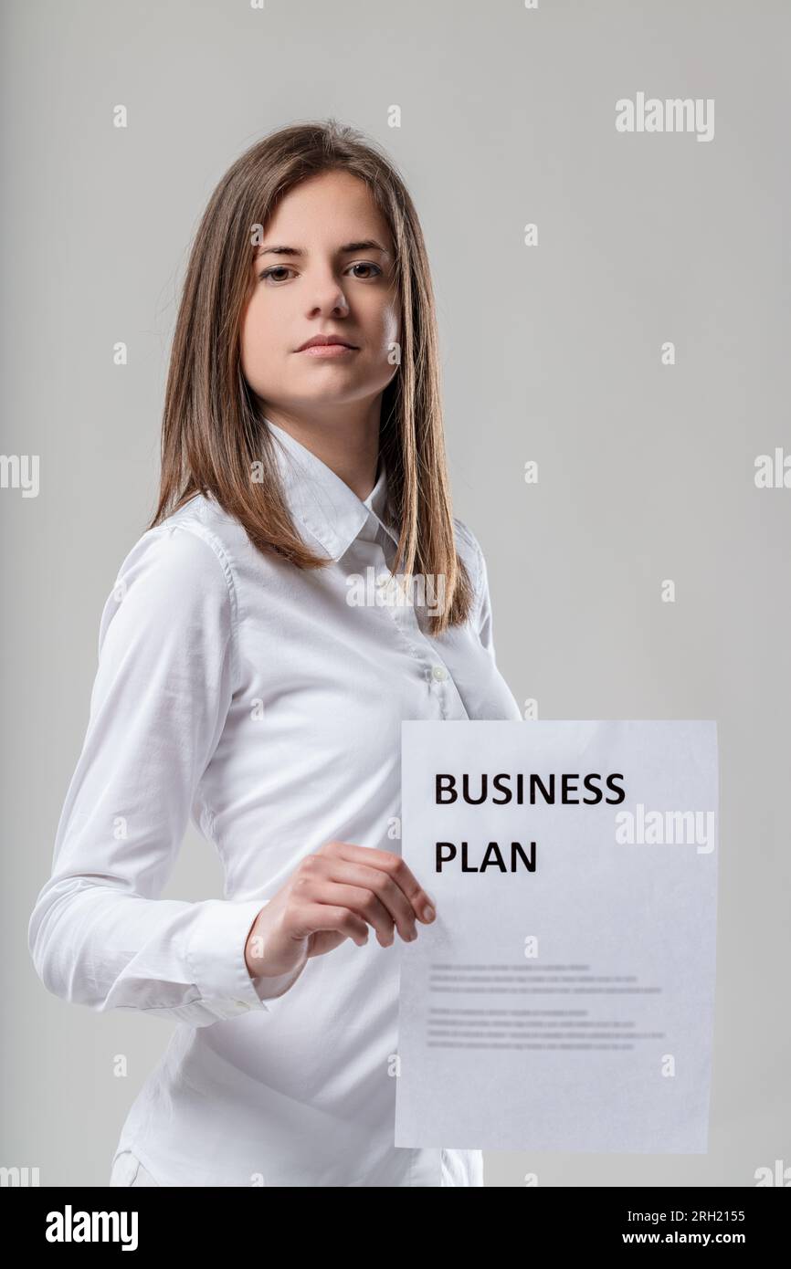 Fierce woman with straight posture presents business plan, in a white ...