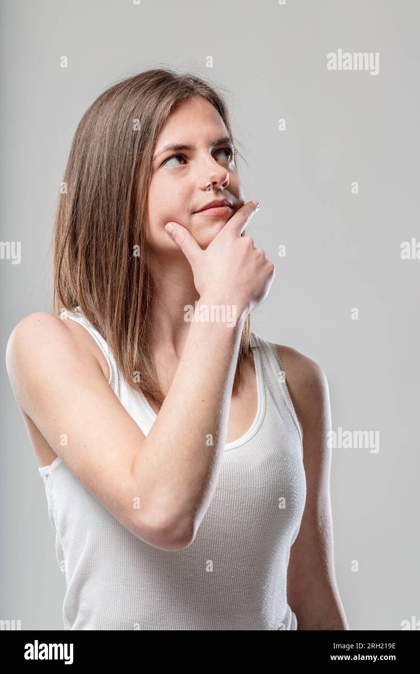 Imaginative woman with medium-length brown hair, fit, in white tank top ...