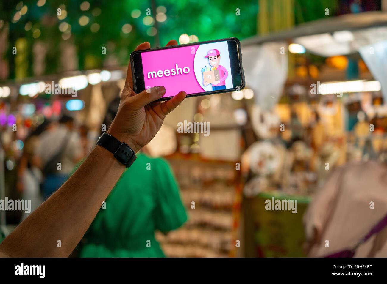 woman holding mobile phone showing indian social commerce startup ...
