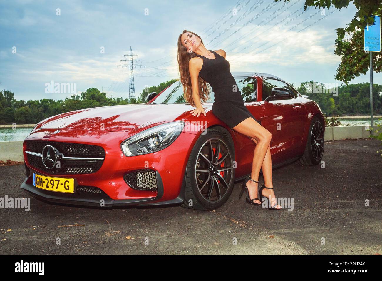 Red Mercedes AMG-GTS sportscar (2015) parked on a road with stylish ...