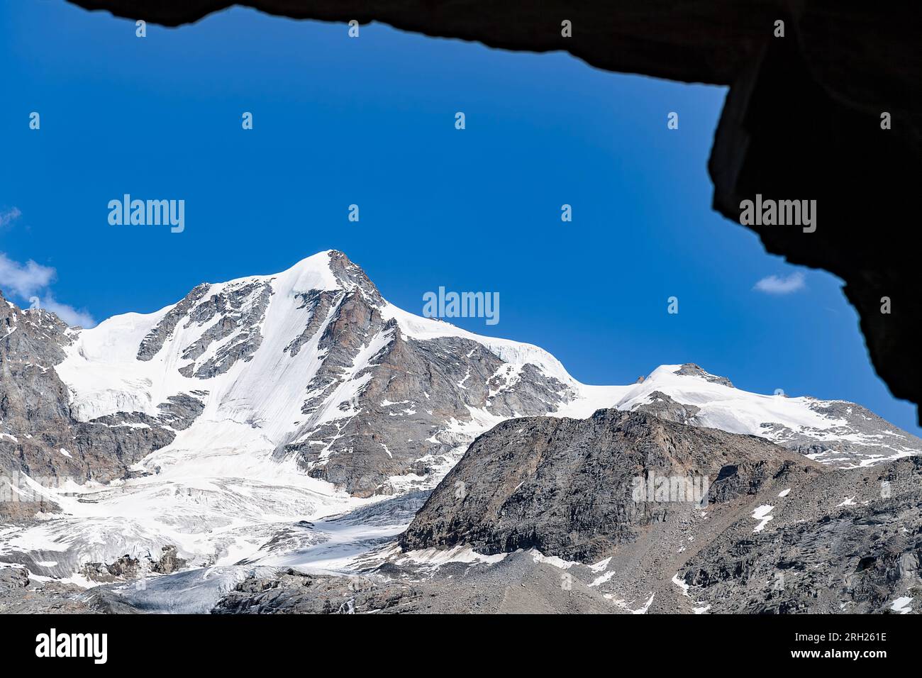From inside a cave, the peak of Gran Paradiso, Alps landscape Stock ...