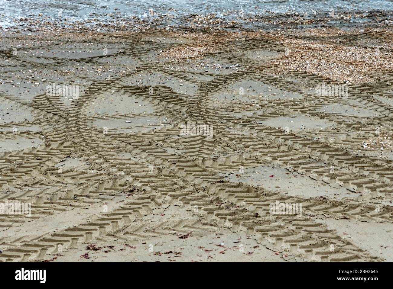 Fresh tractor tyre marks on a sandy beach Stock Photo - Alamy