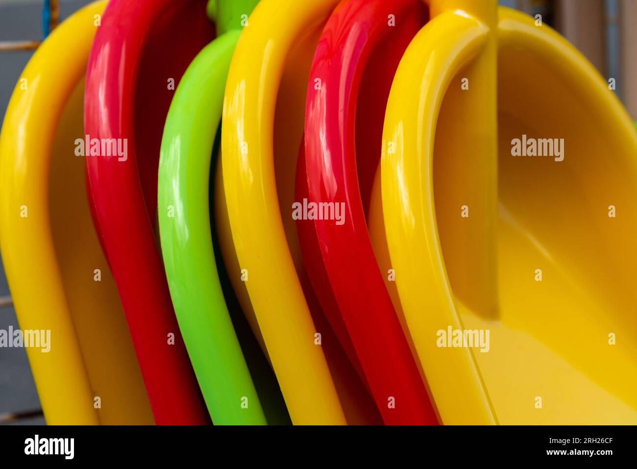 Abstract image, close up of some brightly coloured plastic spades at a ...