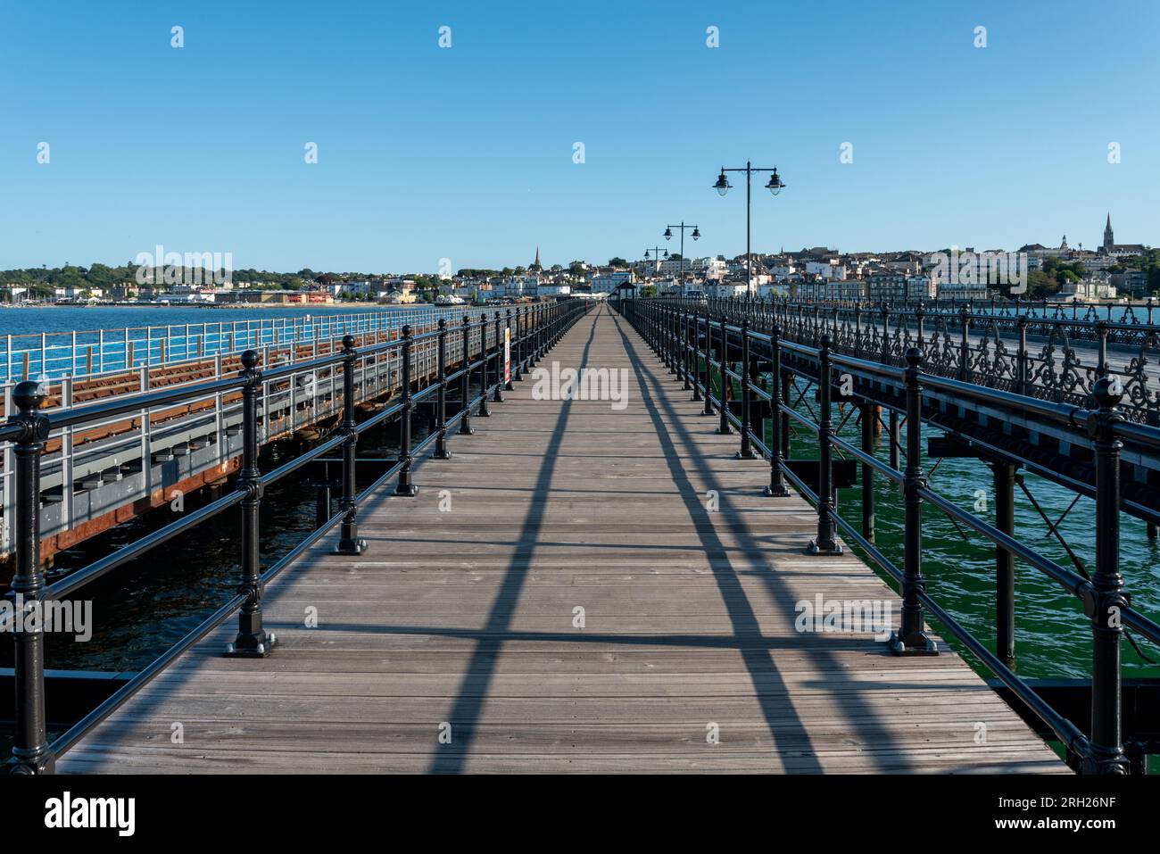 Pedestrian walkway along Ryde pier on the Isle of Wight looking back to ...