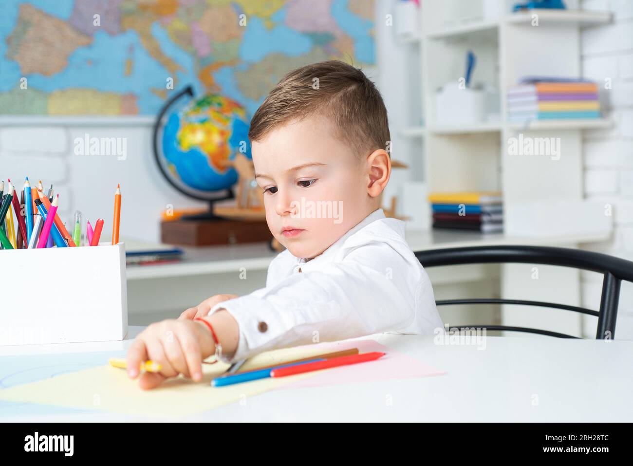 Kid is learning in class on background of blackboard. Education. Home ...