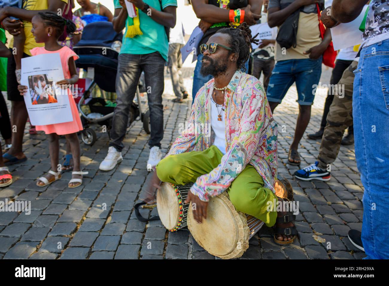 Rome, Rome, Italy. 12th Aug, 2023. A male activist from Senegal plays ...