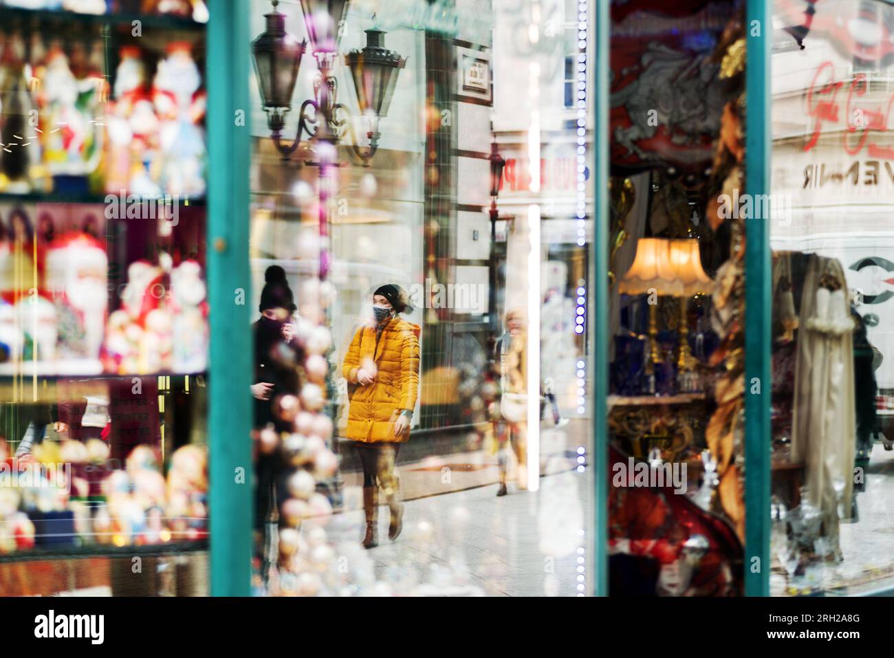 Old city, passers-by reflection in glass case Stock Photo - Alamy