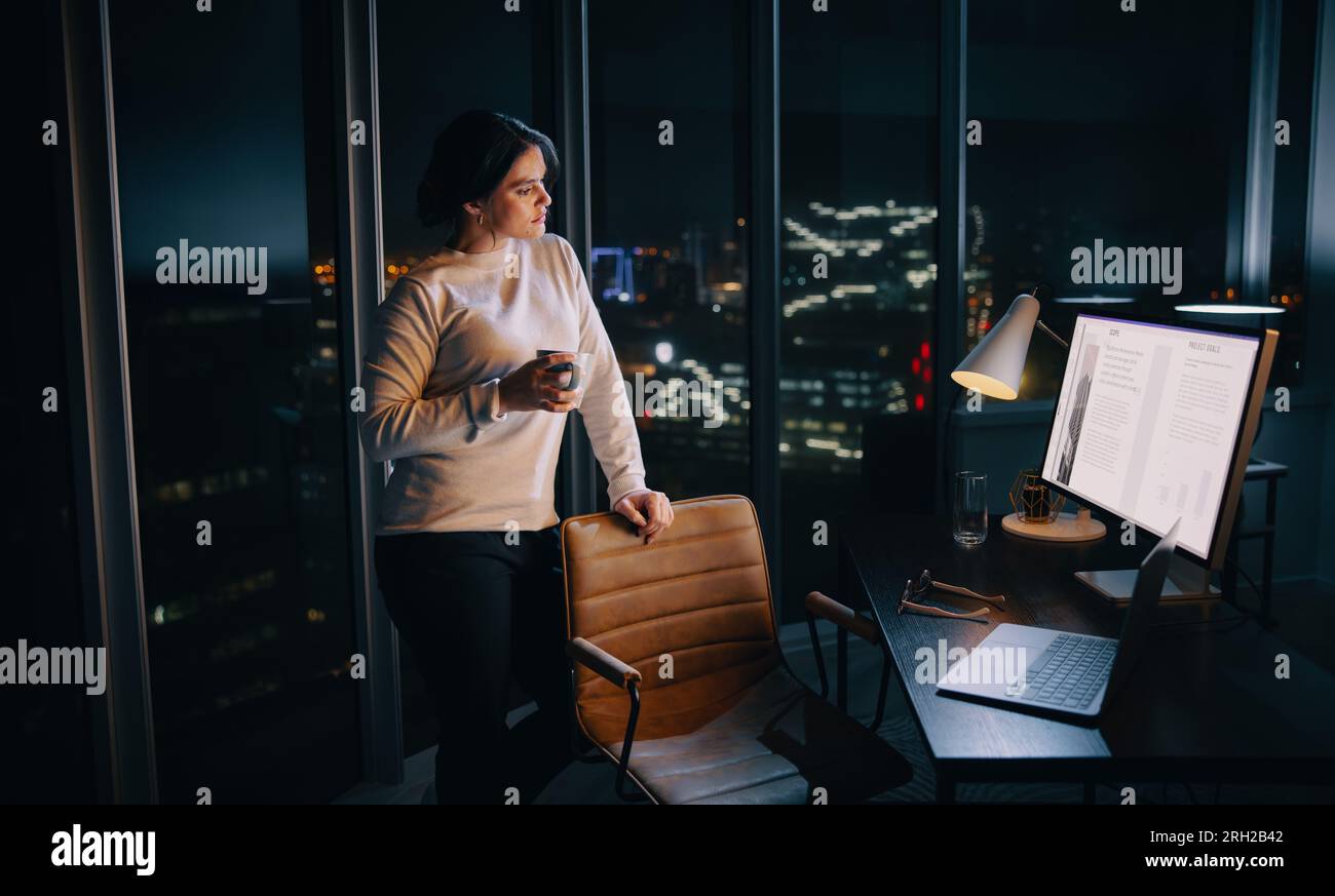 Female office worker working late hi-res stock photography and images ...