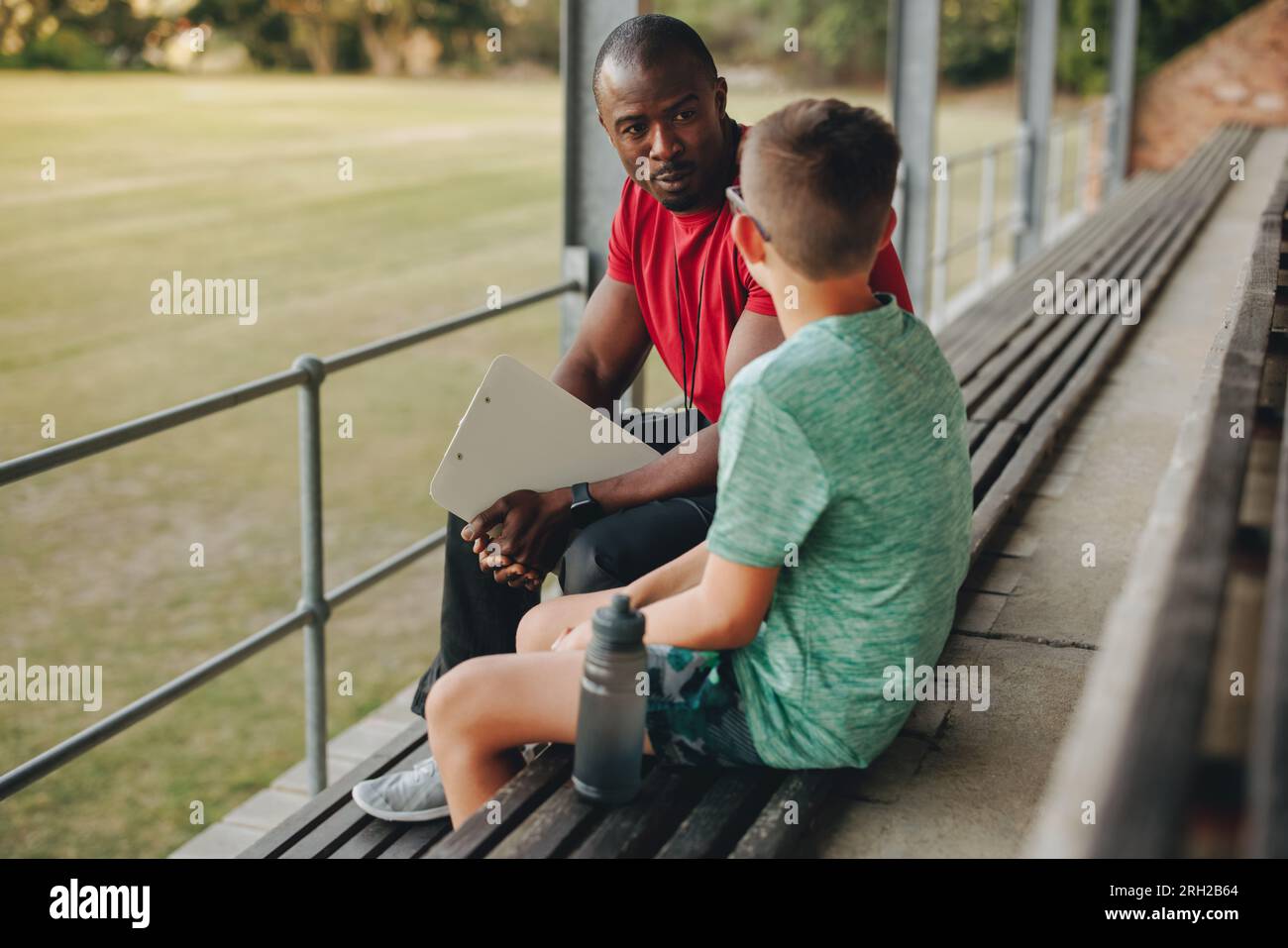 Physical education teacher talking his student outside in a school ...
