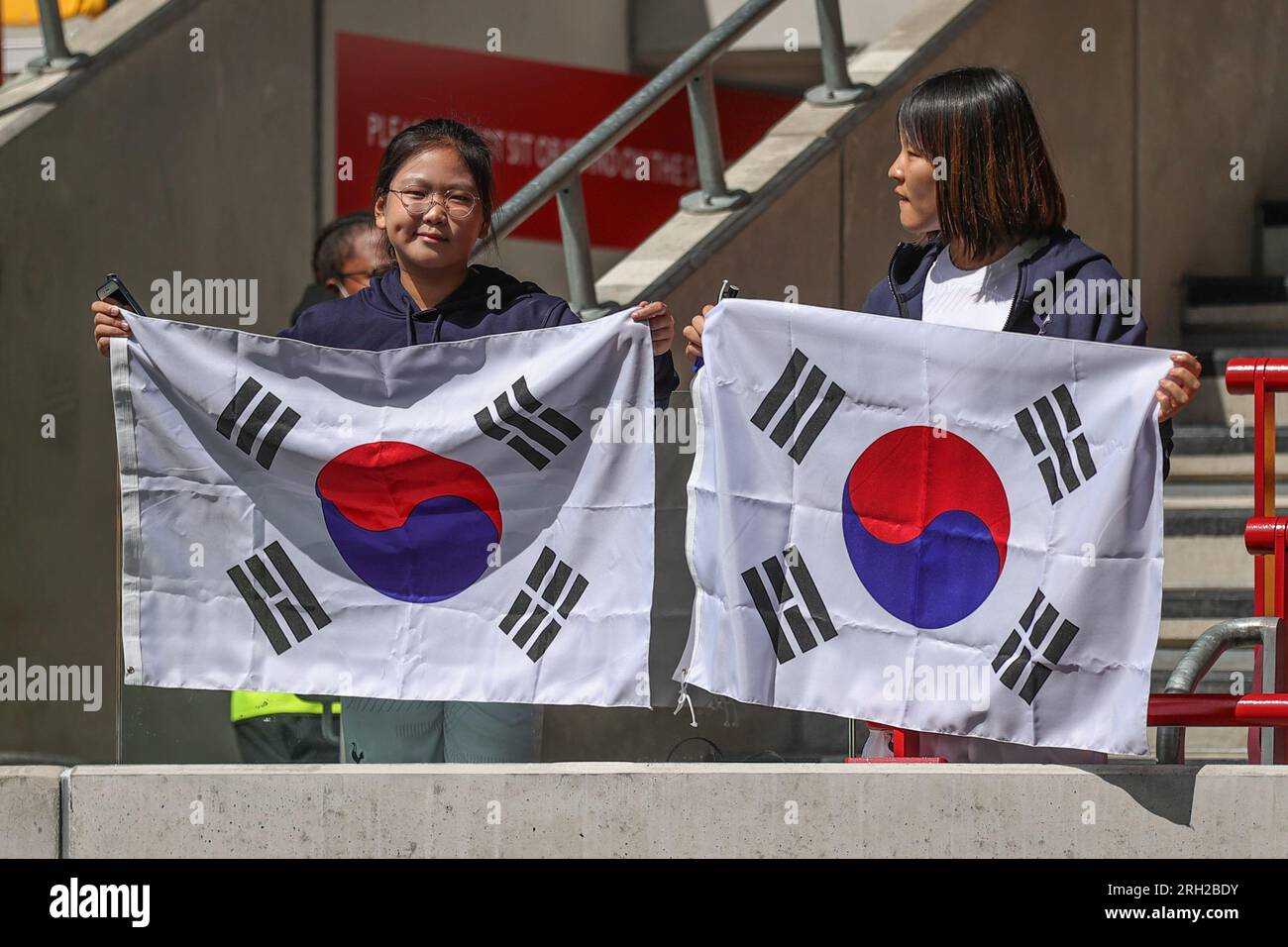 London, UK. 13th Aug, 2023. Two Tottenham fans hold up South Korean ...