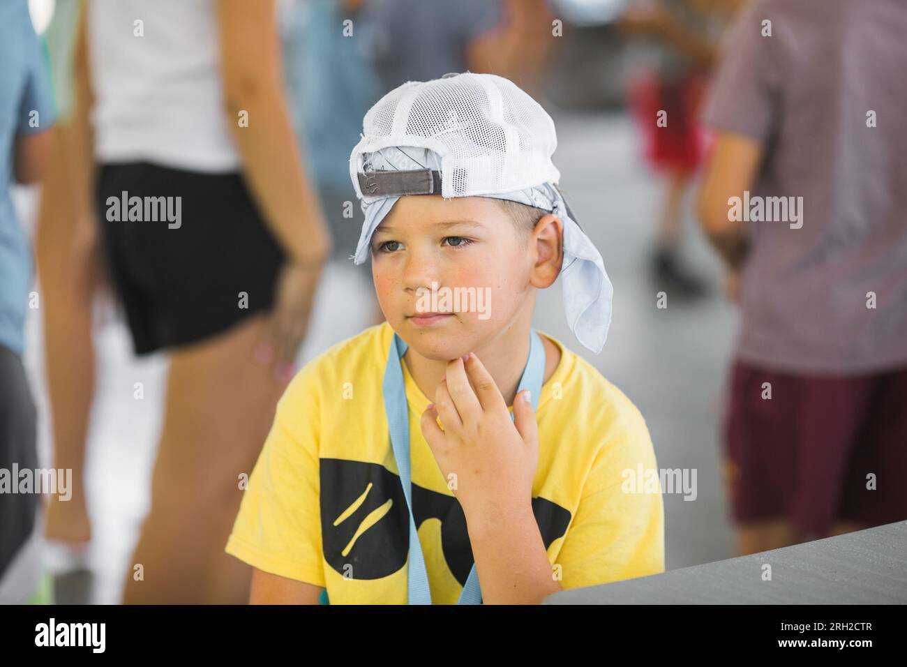 Portrait kid boy looking out with thinking face, children play on in ...