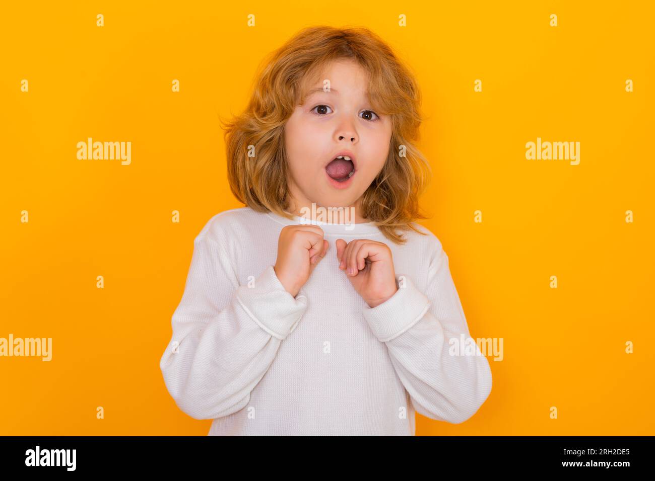 Excited child boy on studio isolated background. Surprised face, amazed ...