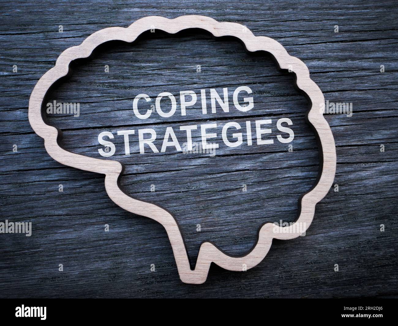 A Brain shape on the old wood with words coping strategies Stock Photo ...