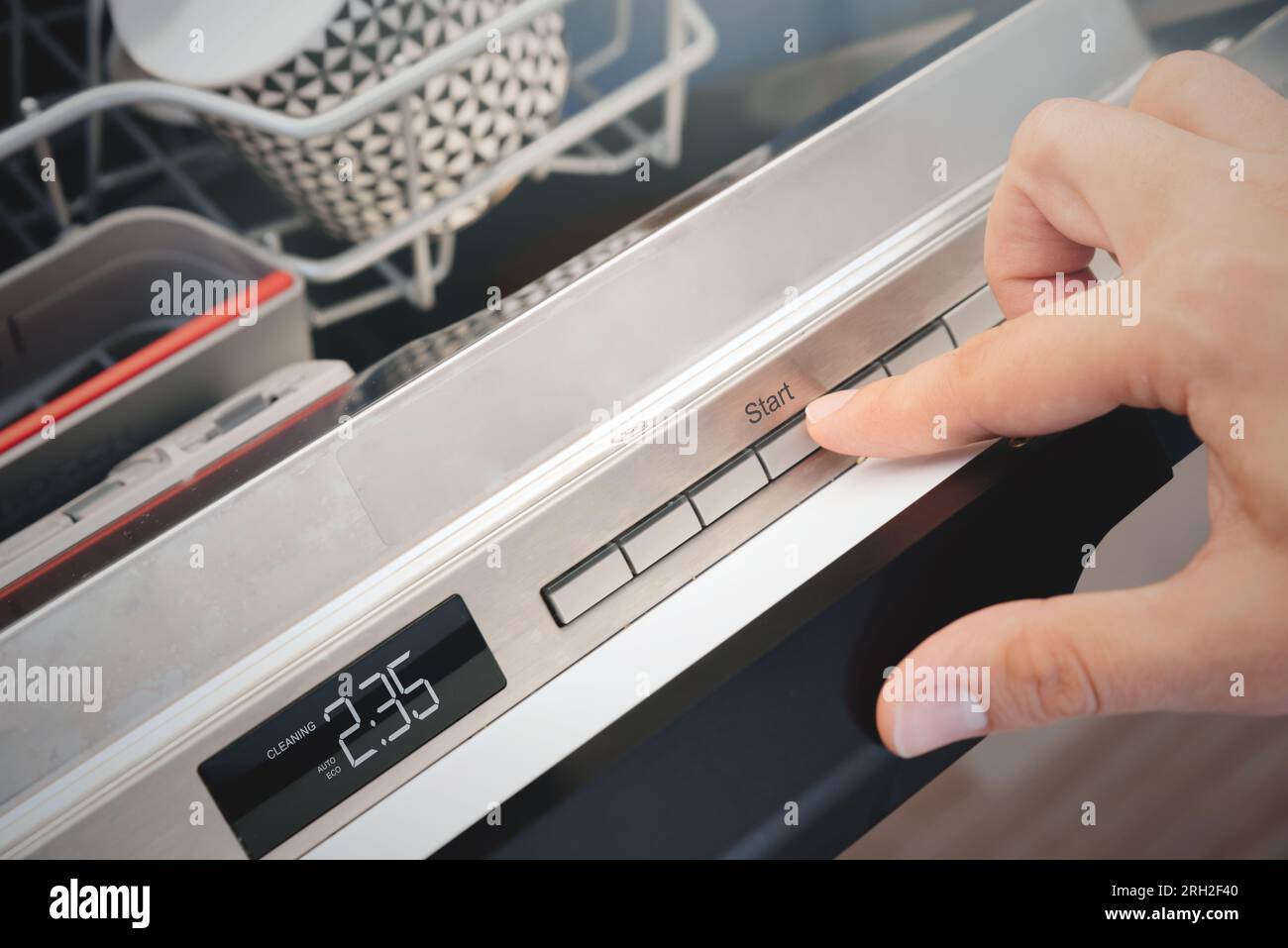 Man pushing start button on the control panel of the dishwasher Stock ...