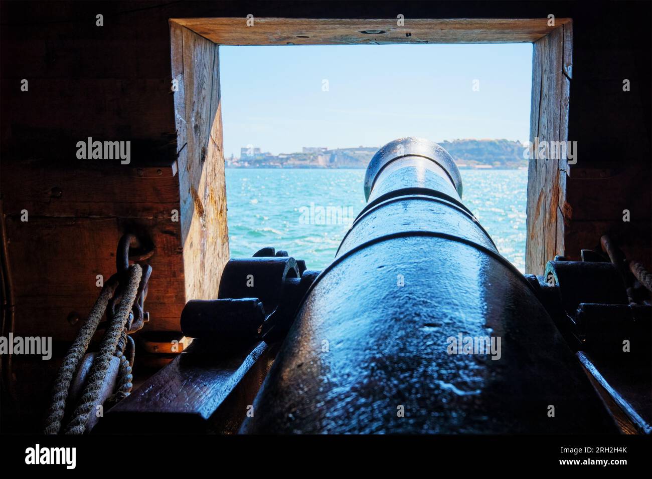View out of a gunport in hull of the ship on the gun deck over the gun ...