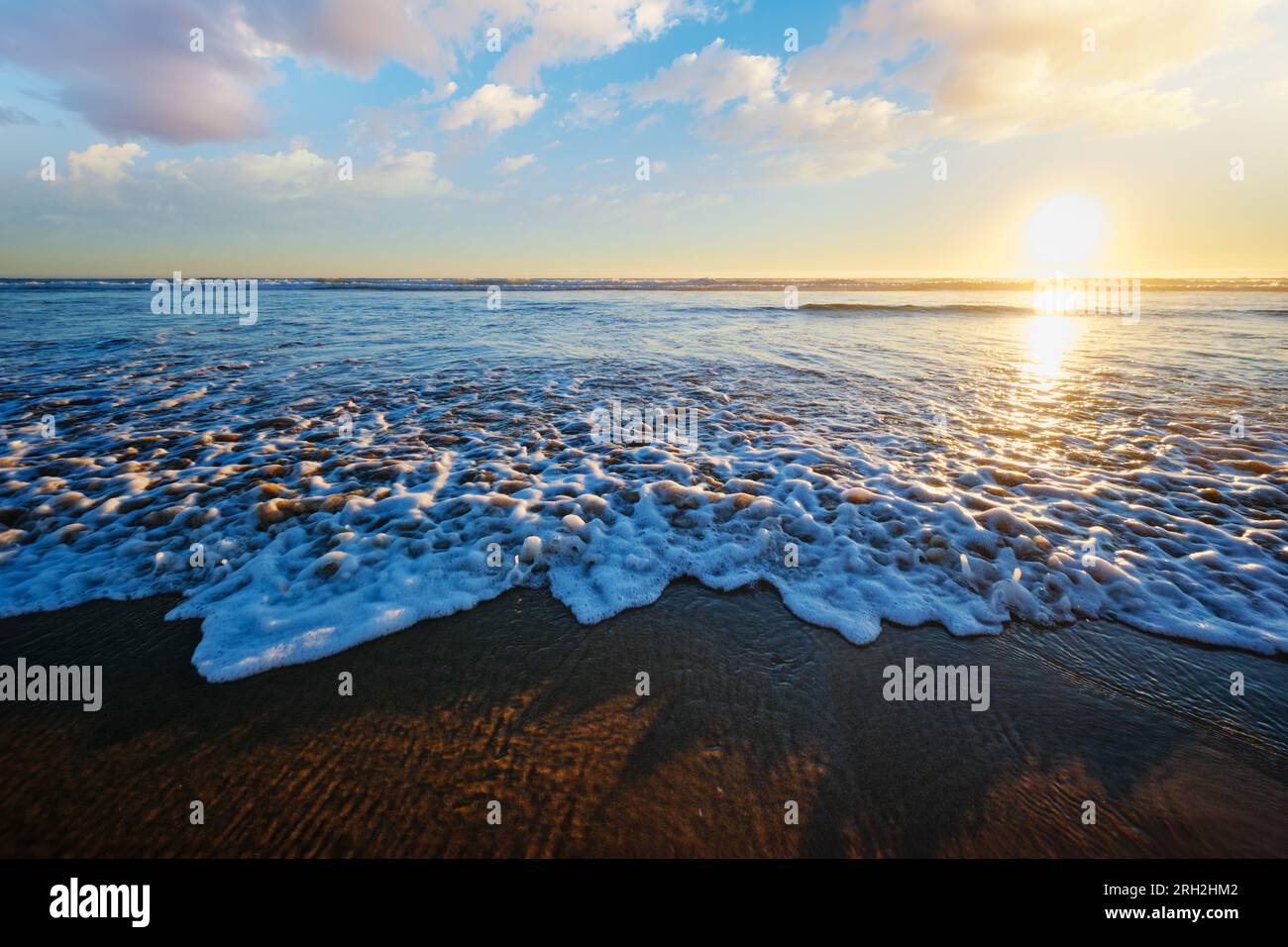 Atlantic ocean sunset with surging waves at Fonte da Telha beach ...