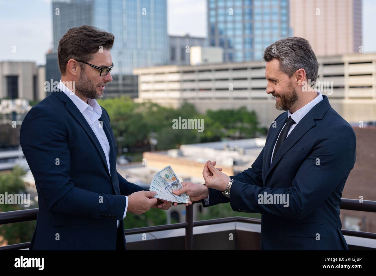 Thoughtful businessman wearing a suit front of office outdoor. Business ...