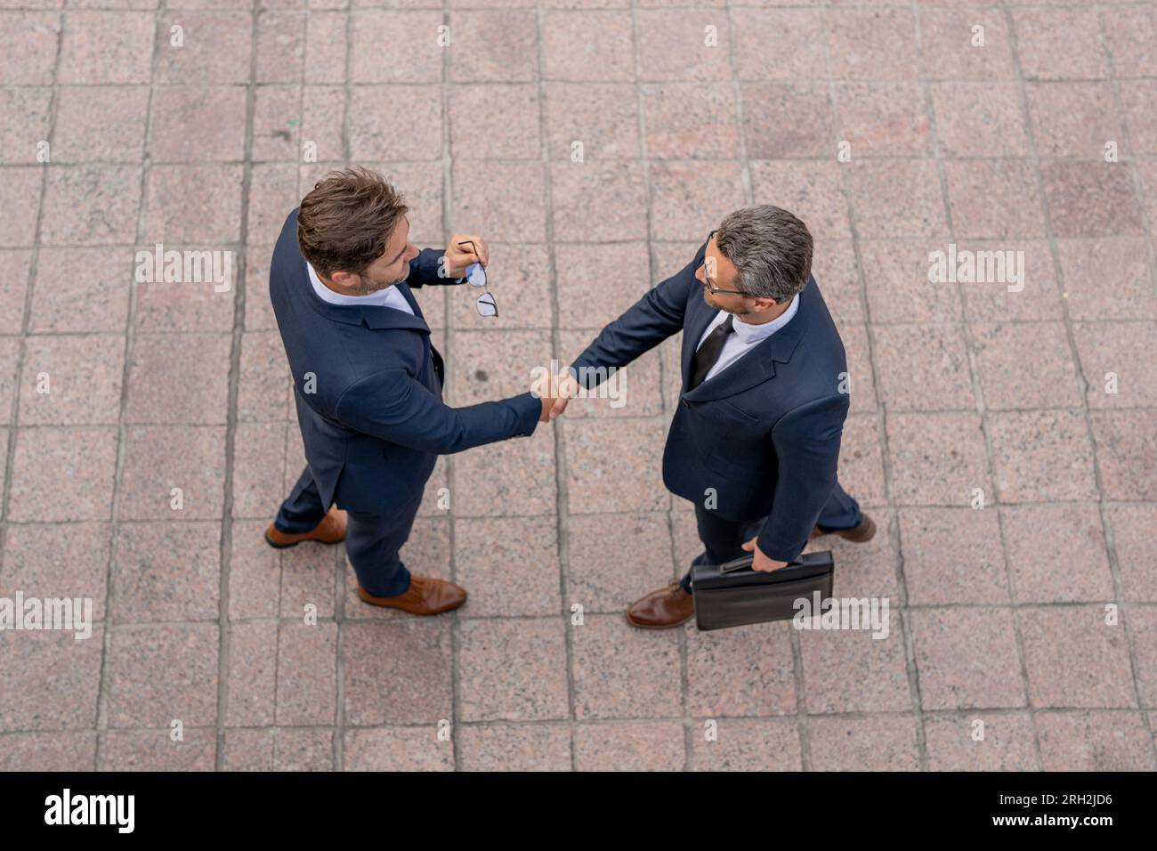 Business man shaking hands. Two businessmen handshake outdoor ...