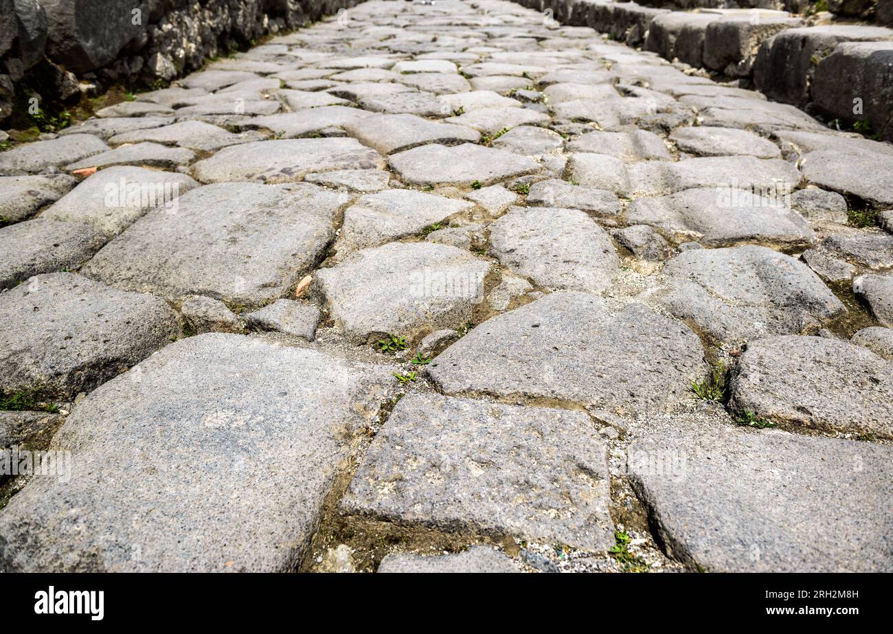 Ancient cobbled road in Pompeii, Italy. Gray granite cobblestones ...