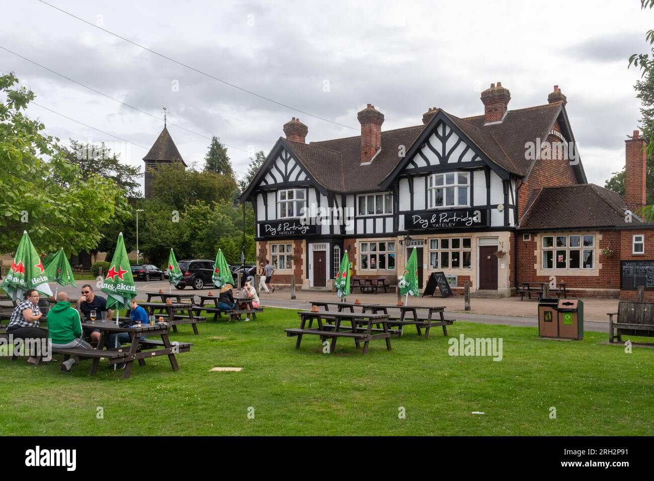 The Dog & Partridge pub in Yateley, Hampshire, England, UK, with people ...