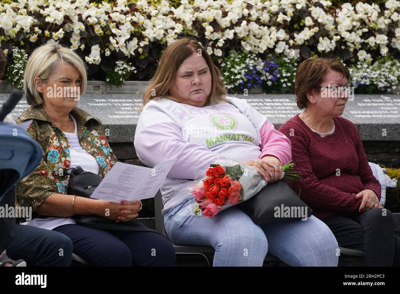 People gather ahead of a service to mark the 25th anniversary of the ...