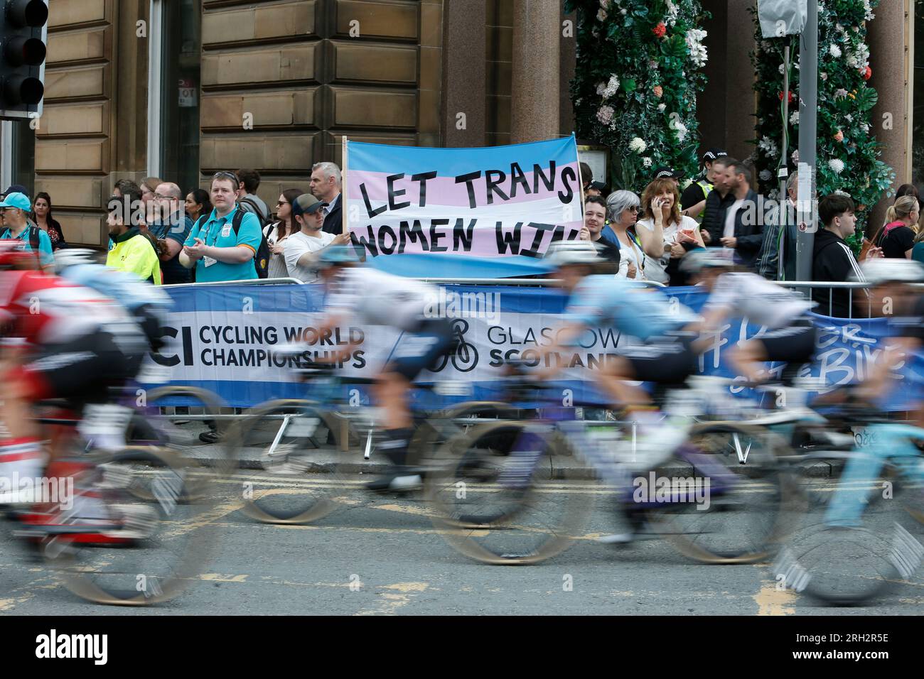 Protestors hold up a banner saying 'Let Trans Women Win' as the ...