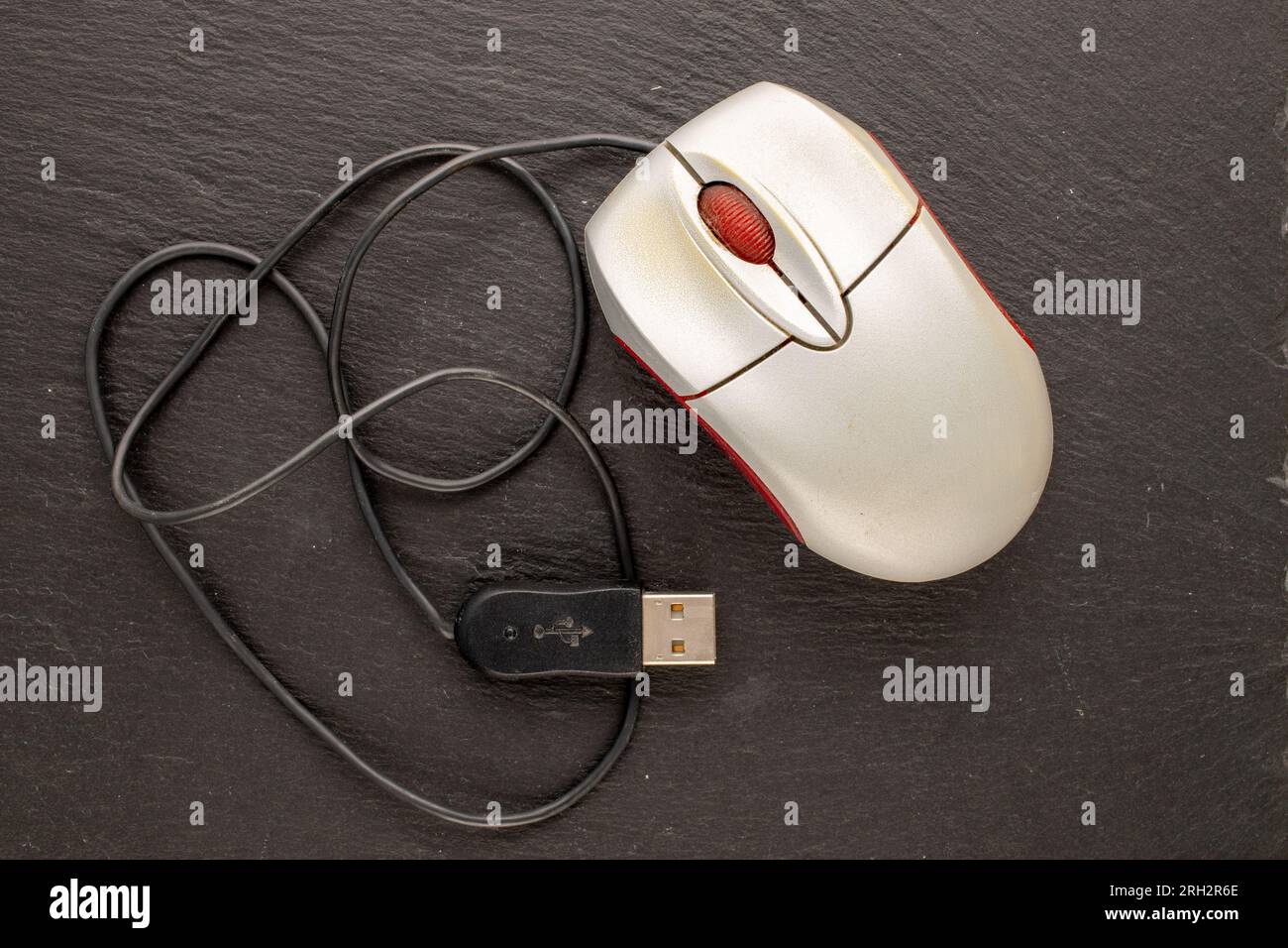 One computer mouse on slate stone, after 20 years of use, top view ...