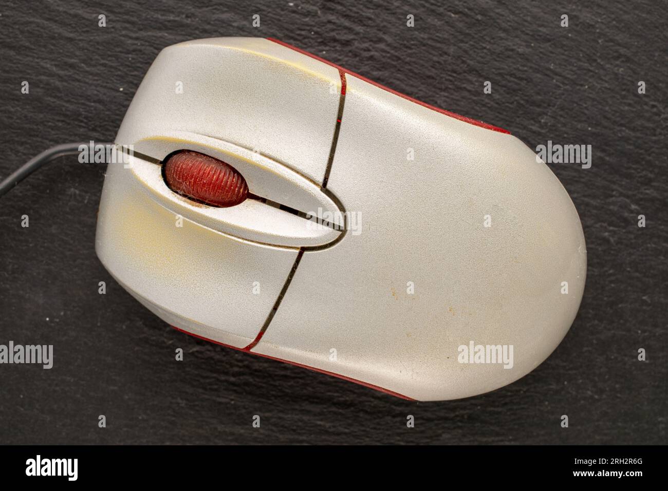One computer mouse on slate stone, after 20 years of use, top view ...