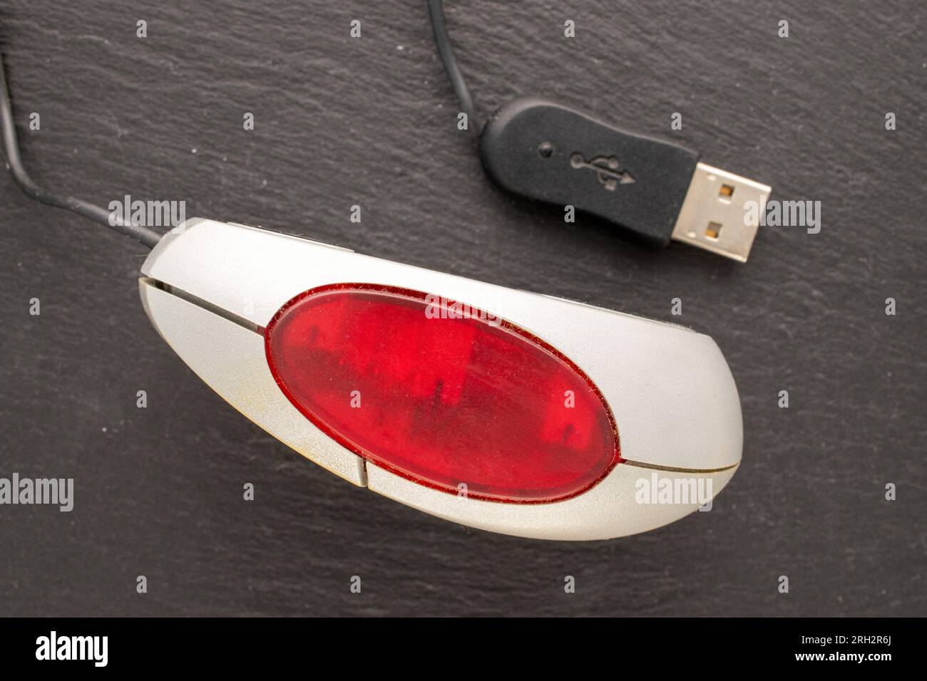 One computer mouse on slate stone, after 20 years of use, top view ...