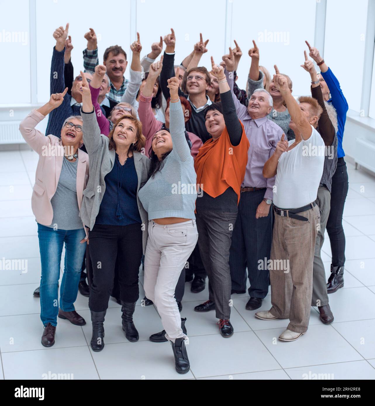 a group of elderly people raised their hands up Stock Photo - Alamy