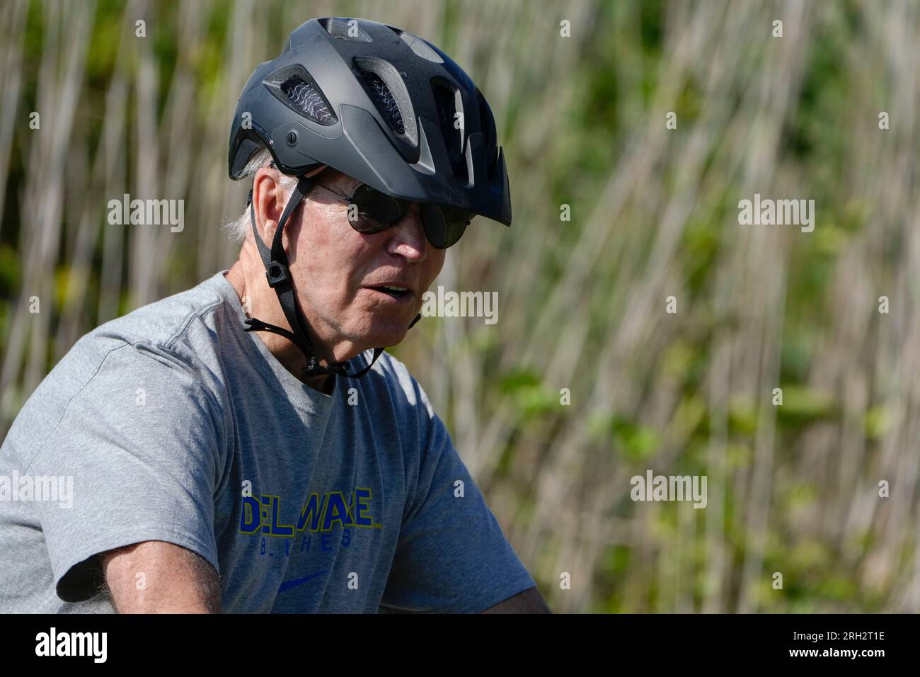 President Joe Biden rides his bike at Gordons Pond in Rehoboth Beach ...