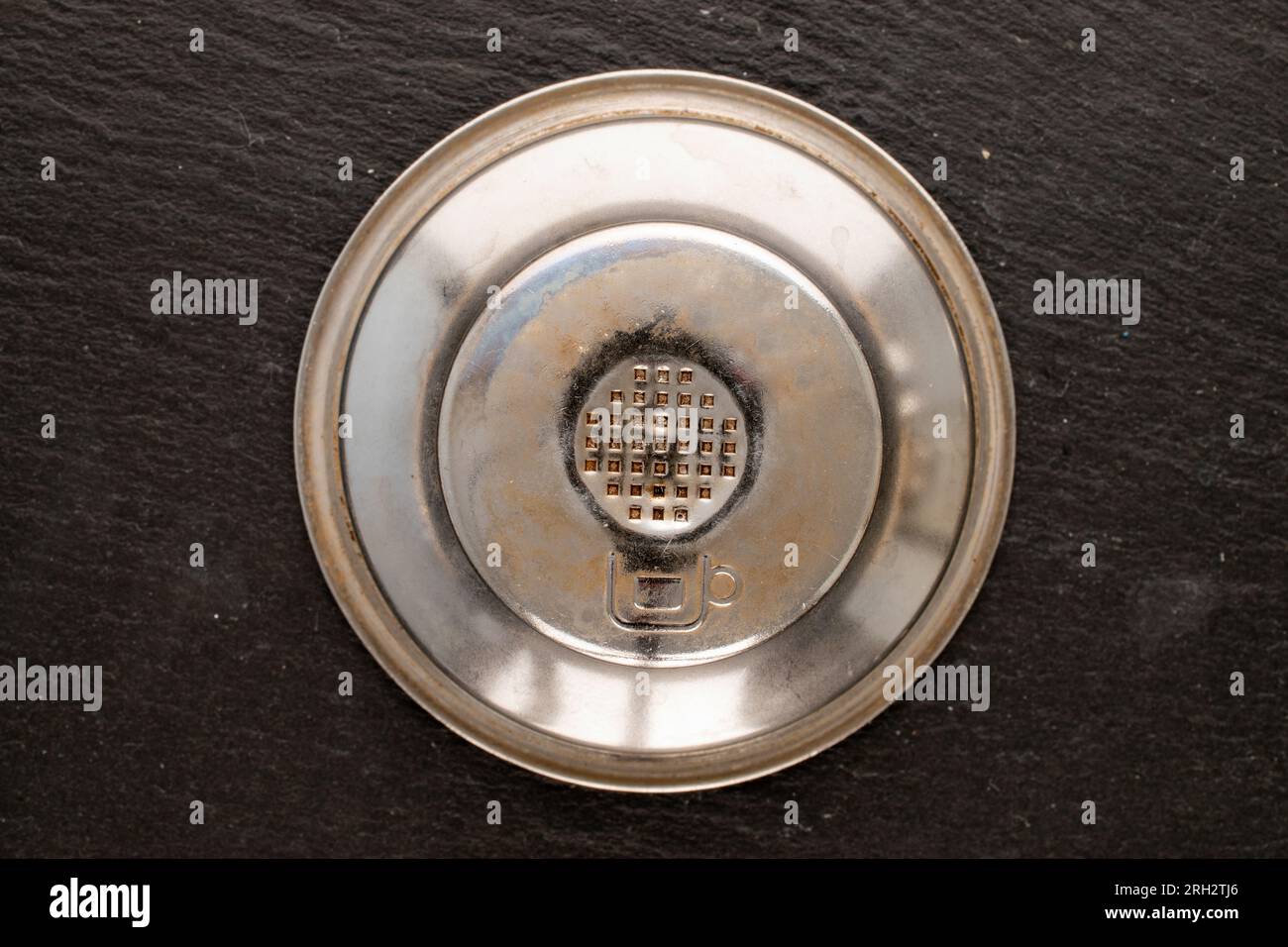 One metal coffee maker sieve on slate stone, macro, top view Stock ...