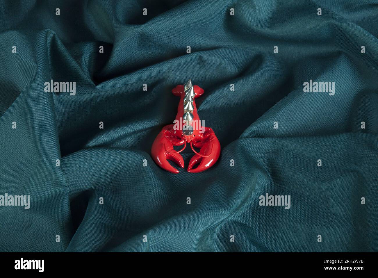 a punk style lobster wearing riveted spikes like a mohican on a green ...