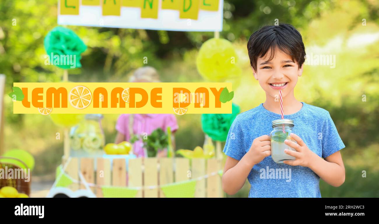 Cute little boy drinking lemonade in park Stock Photo - Alamy
