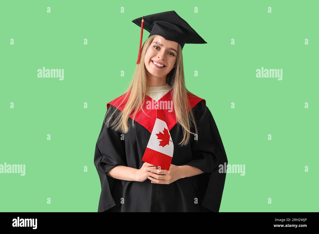Female graduate student with Canadian flag on green background Stock ...