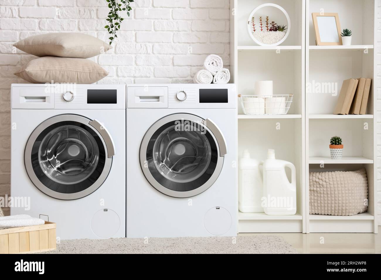 Interior of laundry room with washing machines and shelving unit Stock ...