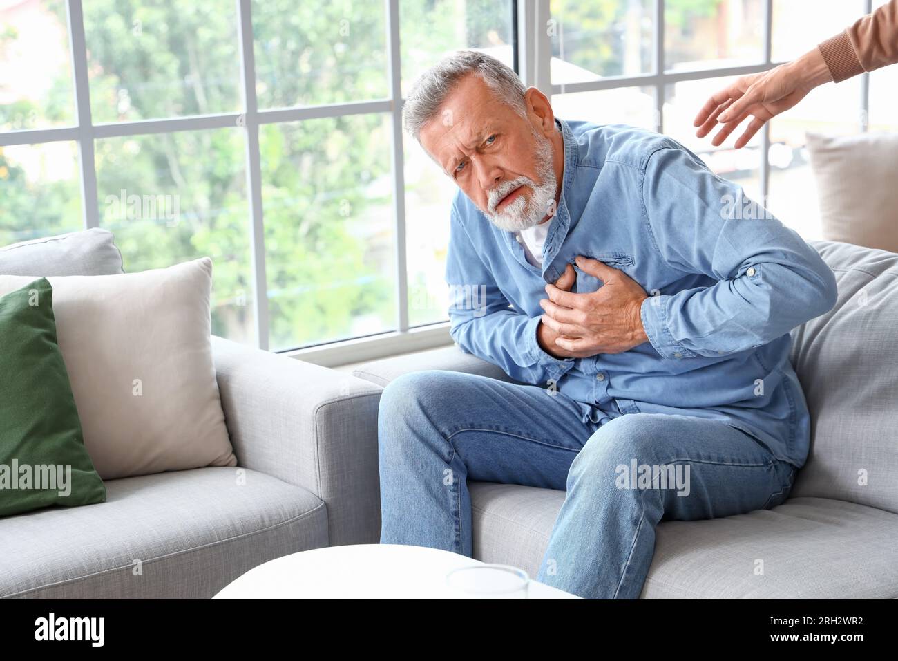 Mature man having heart attack at home Stock Photo - Alamy