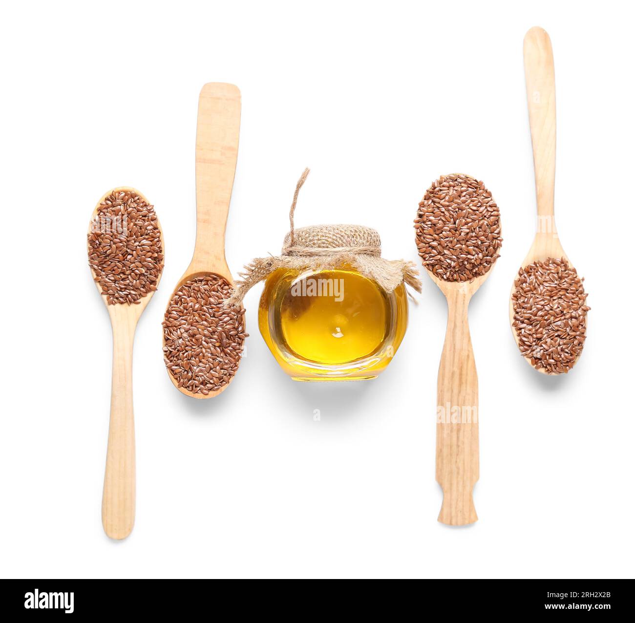 Jar of flax oil and wooden spoons with seeds on white background Stock Photo - Alamy